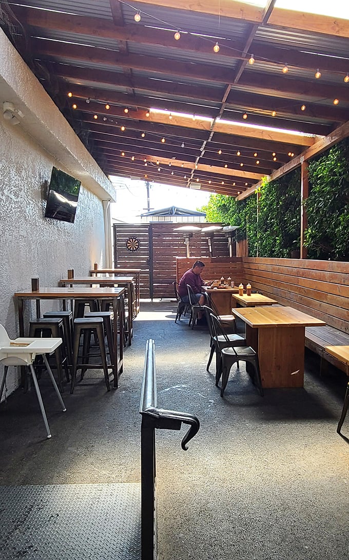 The outdoor patio: where string lights, wooden tables, and the lingering scent of smoke create the perfect setting for making important life decisions about second helpings.