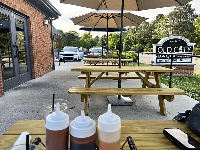 Sauce bottles standing at attention on outdoor tables—the condiment equivalent of "locked and loaded" for your barbecue battle.