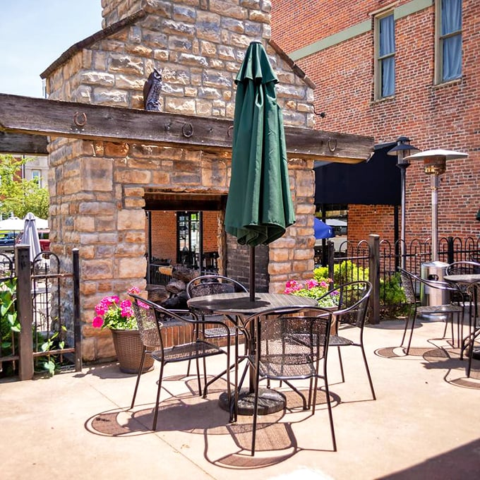The stone patio creates an outdoor oasis where summer afternoons stretch into evenings. Those flowers aren't just pretty—they're nature's endorsement of your dining choice.