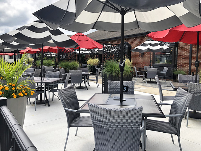 Outdoor dining under striped umbrellas—like a sophisticated beach club, minus the sand in your shoes and plus the incredible food on your table.