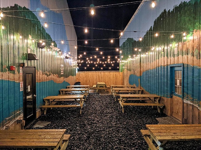 String lights twinkle above this outdoor sanctuary where picnic tables await beneath the stars—barbecue's natural habitat.