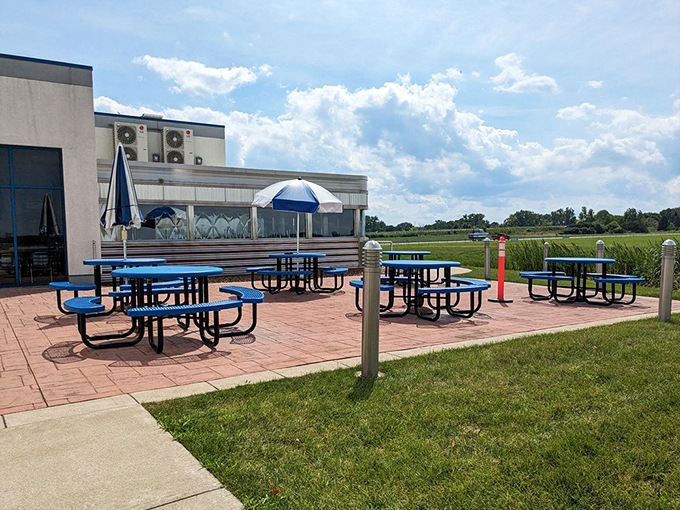 The outdoor seating area offers blue-sky dining with a side of aviation views—perfect for those "I need some fresh air with my fries" moments.