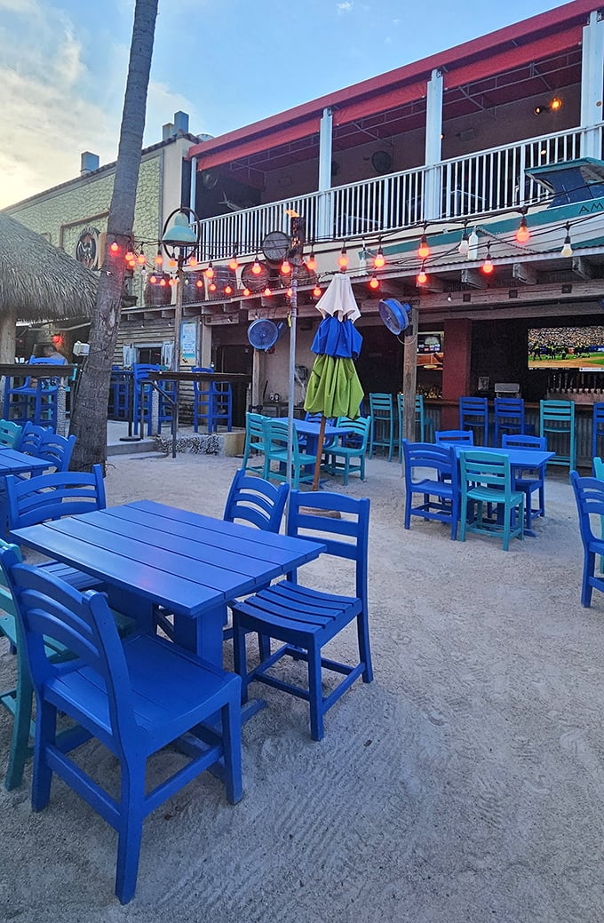 Beach vibes intensify with these brilliant blue chairs and string lights – dinner with your toes in the sand is what vacation dreams are made of.