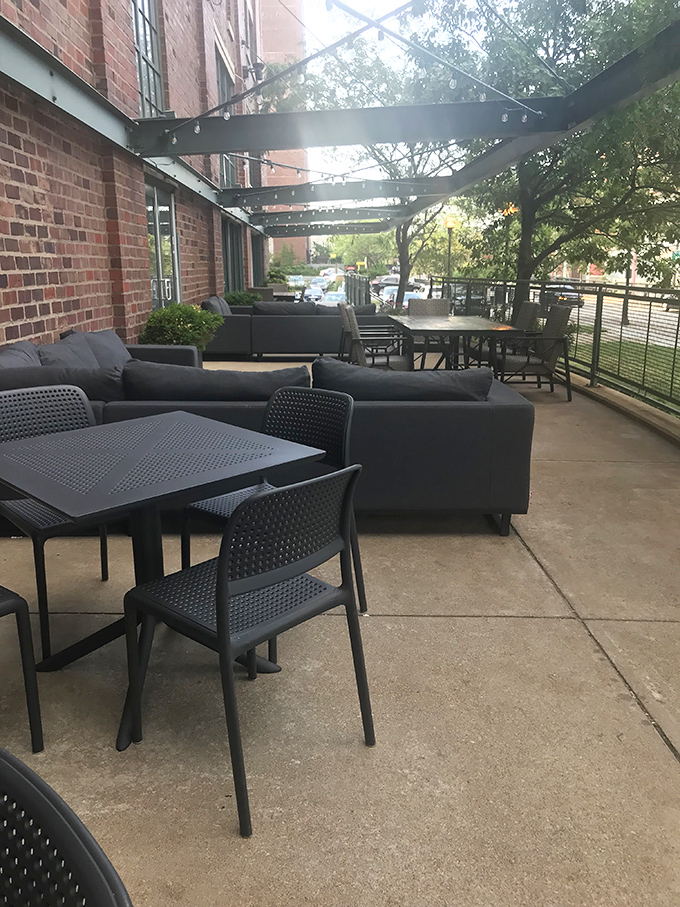 The outdoor patio offers urban oasis vibes—comfortable seating under string lights where coffee conversations can stretch lazily into evening hours.