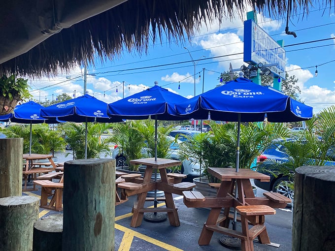 Outdoor seating that captures the essence of Florida dining—blue umbrellas, wooden tables, and the promise of fresh catches.