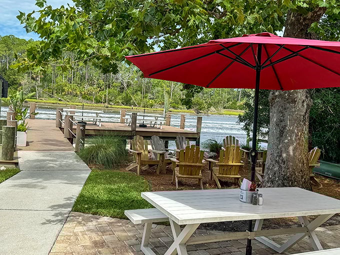 The outdoor seating area – where Adirondack chairs, waterfront views, and Florida sunshine create the perfect pre-dinner waiting spot.