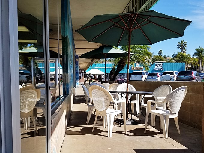 Outdoor seating with umbrella shade—because eating donuts al fresco makes them practically health food, right?