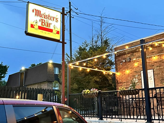 As evening falls, the outdoor patio beckons with string lights and the iconic Meister's sign guiding hungry travelers home like a beacon.