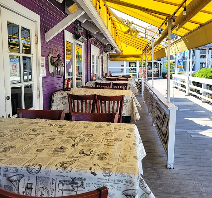 The purple exterior and yellow awning create a cheerful backdrop for outdoor dining—newspaper-print tablecloths hint at the messy deliciousness to come.