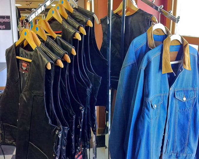 Vintage leather vests hang alongside denim jackets—sartorial time machines ready to transport their new owners back to cooler decades.