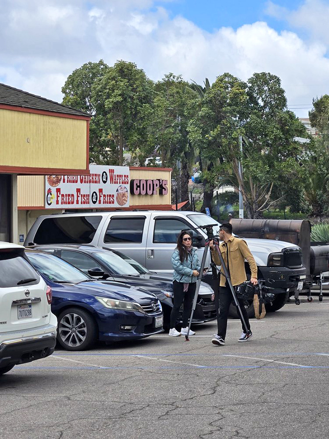 The parking lot—where anticipation begins and satisfied customers waddle back to their cars in a post-barbecue daze.