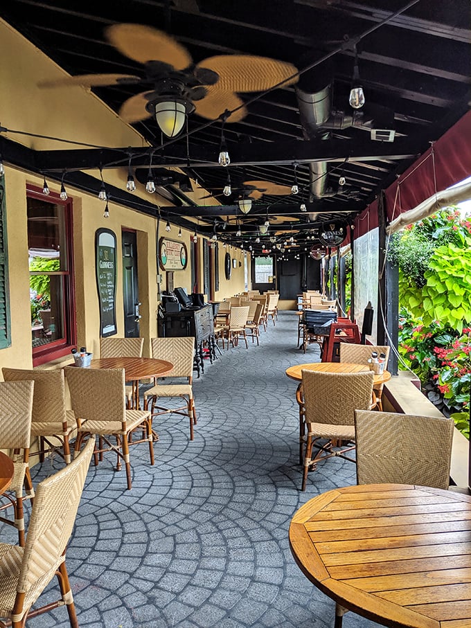 The covered patio offers al fresco dining without weather worries – string lights overhead turning ordinary evenings into something magical.