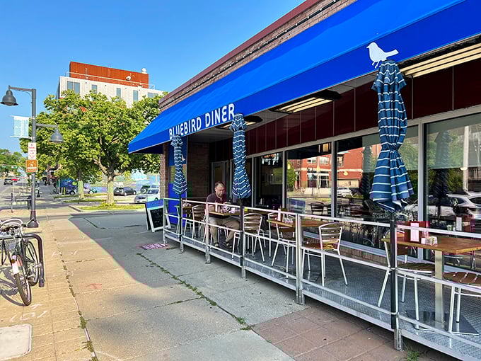 Outdoor seating at the Bluebird isn't just an option—it's front-row tickets to Iowa City's daily parade of life.