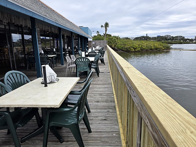 The outdoor deck—where the restaurant's name makes perfect sense—offers waterfront dining without the waterfront prices. Those plastic chairs have witnessed countless sunset toasts.