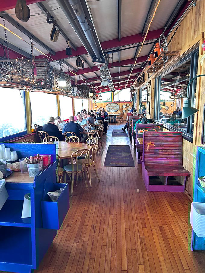 The bustling dining room stretches toward water views – a lively space where seafood stories and family memories are made between bites.