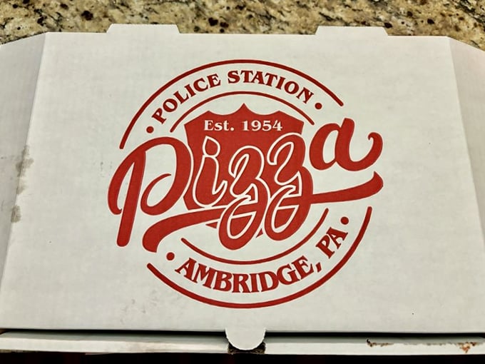The pizza box logo tells the story—established 1954, when Eisenhower was president and great pizza was already a priority.