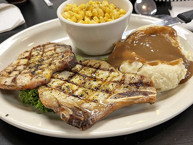 Pork chops grilled with perfect crosshatch marks share the plate with corn and mashed potatoes—a trio that's been making Americans happy for generations.