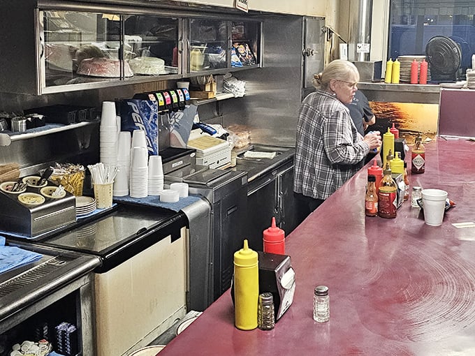 Behind the counter, condiment bottles stand at attention like soldiers ready for duty in the delicious battle against bland food.