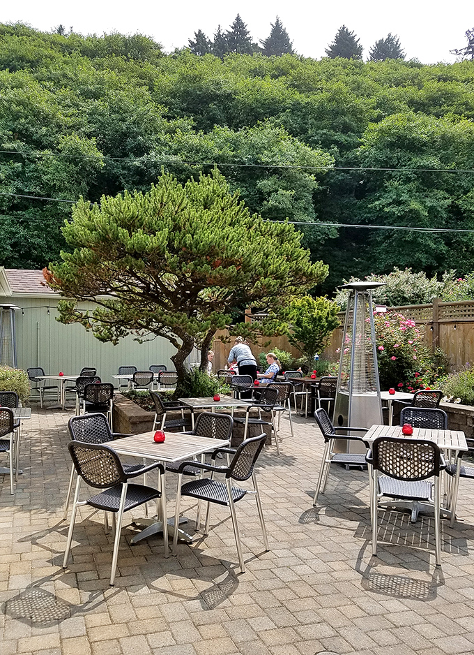 This garden patio invites lingering conversations over local wine, where the soundtrack is birdsong and distant waves rather than traffic.