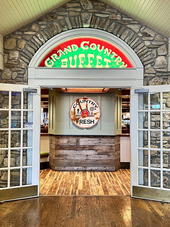The stone archway entrance with its illuminated sign doesn't just say "welcome"—it practically whispers "come on in, the biscuits and gravy are waiting."