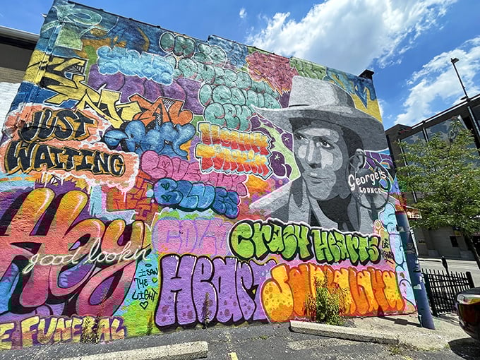 Sunshine makes the mural pop with even more vibrant energy. "Just Waiting" indeed—for you to come experience this Canton institution.