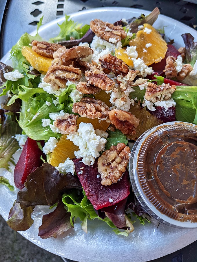 A salad that doesn't apologize for being at a barbecue joint. Bright, fresh, and studded with candied pecans and goat cheese.