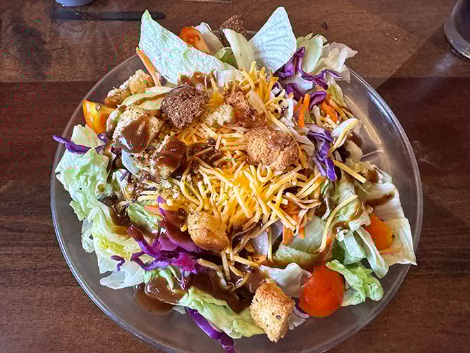 A salad that doesn't apologize for being delicious, topped with enough cheese and dressing to make you forget you're eating something healthy.