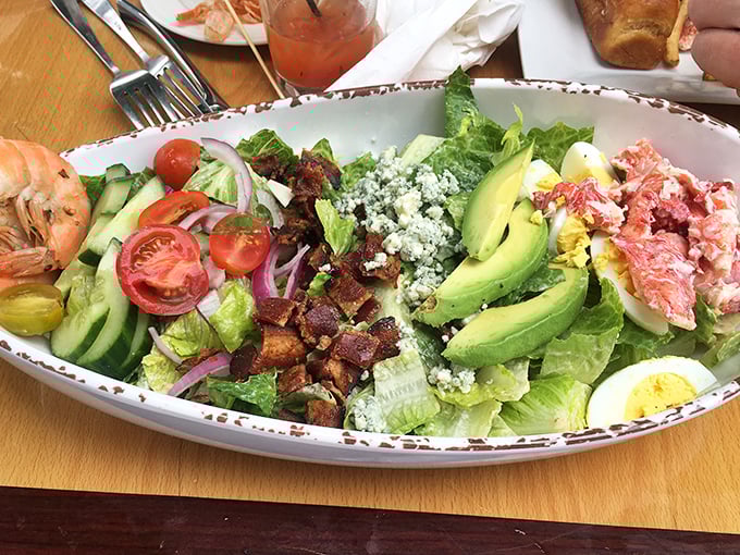 This isn't just a salad—it's a colorful convention where avocado, bacon, and seafood meet to discuss how delicious they are together.