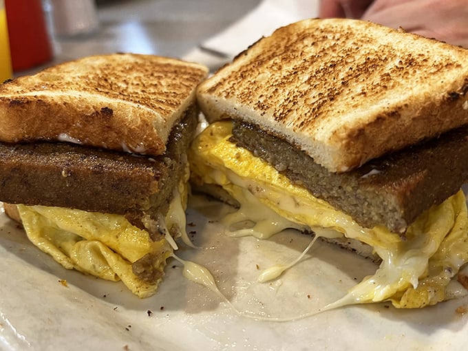 This breakfast sandwich means business—golden egg and melted cheese between perfectly grilled bread. Simple pleasures are often the most satisfying.