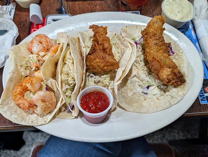 Fish tacos that balance crispy and creamy, spicy and cool—proof that the best food doesn't need white tablecloths, just honest ingredients.