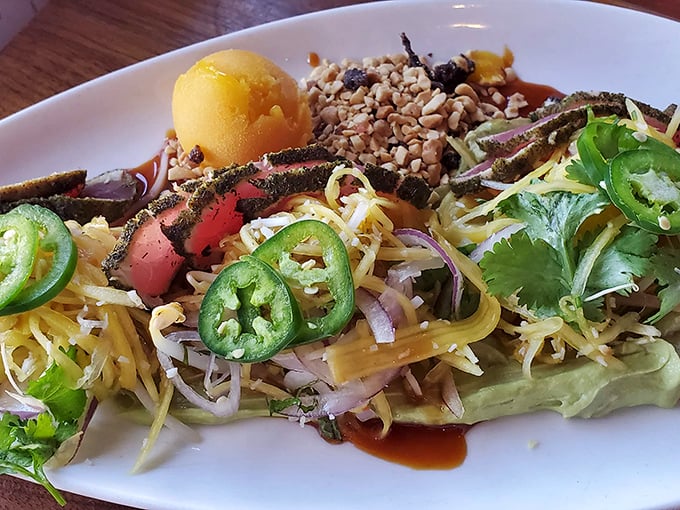Rare tuna nestled among vibrant vegetables and grains—proof that healthy eating and indulgence aren't mutually exclusive concepts.