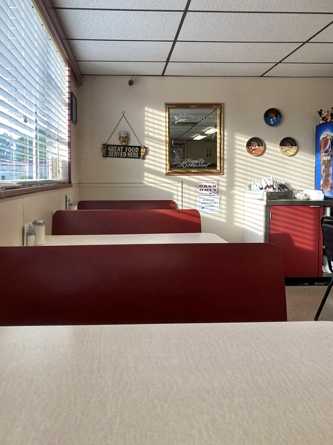 Red vinyl booths bathed in morning light—where "Great Food Served Here" isn't just a sign on the wall, it's a promise kept daily.