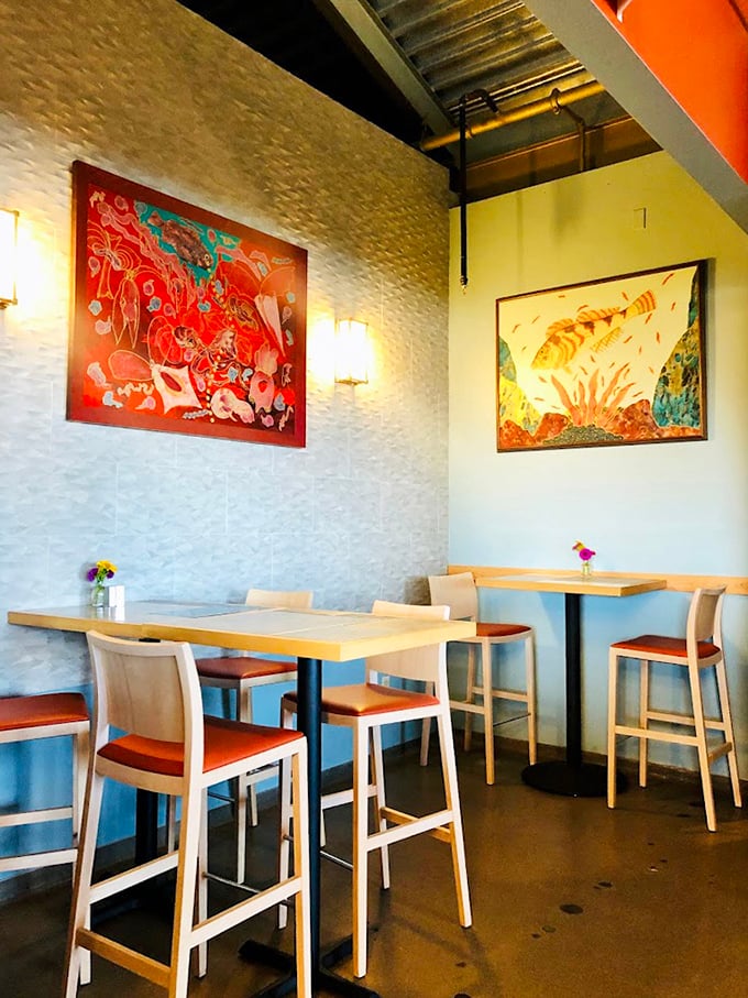 Colorful artwork and clean lines create a dining space that feels both sophisticated and welcoming—like the coastal home of your most culinarily talented friend.