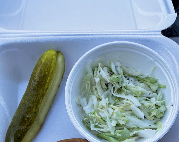 A pickle and coleslaw—the unsung heroes of any great sandwich meal, bringing that perfect acidic counterpoint to rich flavors.