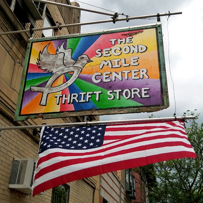 The vibrant rainbow sign with its dove symbol promises more than just bargains—it's a beacon of second chances for items and shoppers alike.