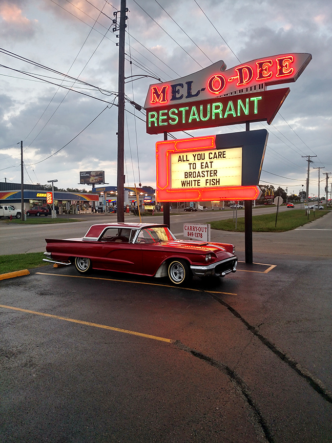 That neon sign has guided hungry travelers like a lighthouse of comfort food for generations. Even classic cars know where to find the good stuff. 