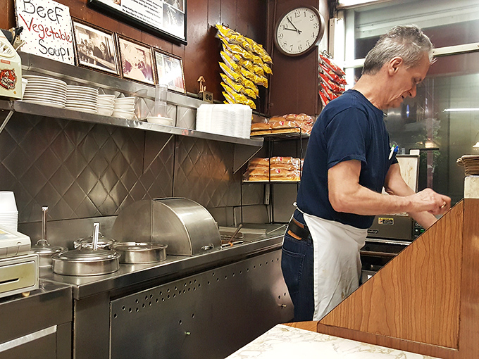 The true heart of any great diner is the people who work there. This cook's focused concentration is the secret ingredient in every dish.