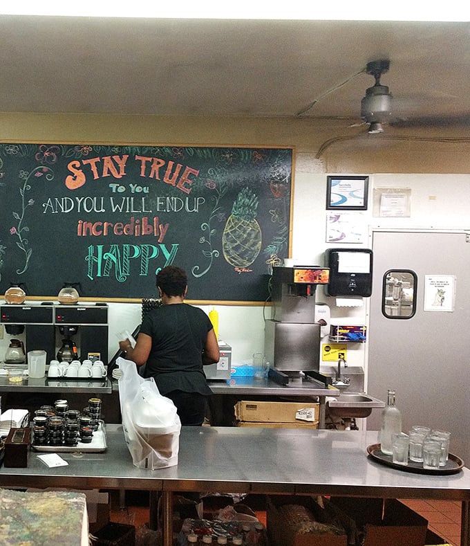 Behind the scenes, staff work their magic beneath an inspirational reminder. That chalkboard wisdom—"Stay true to you"—seems to infuse everything they create.