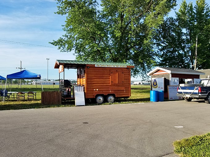 Morning light bathes the fairgrounds as vendors prepare for the day ahead, arranging their wares with the care of museum curators displaying priceless artifacts.