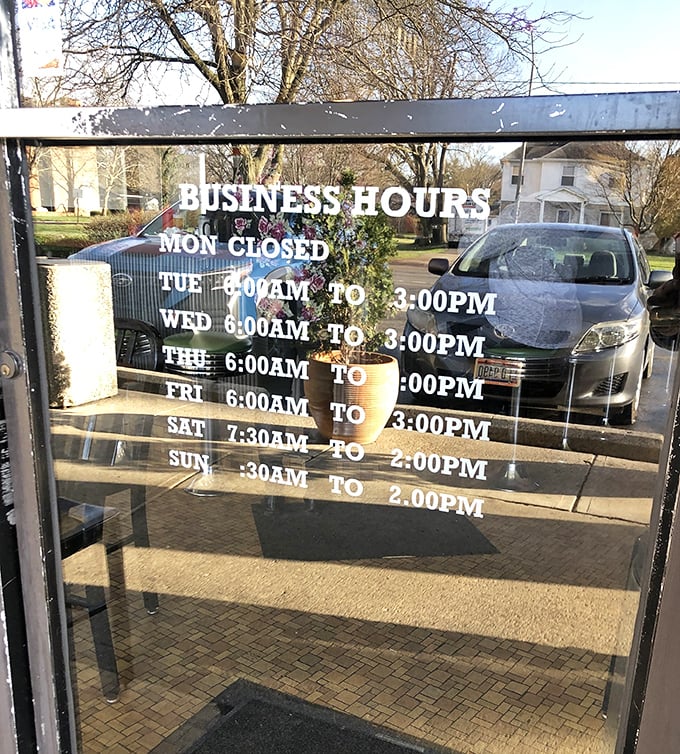 The business hours sign—a roadmap to happiness that wisely includes being closed on Mondays, because even breakfast legends need a day off.