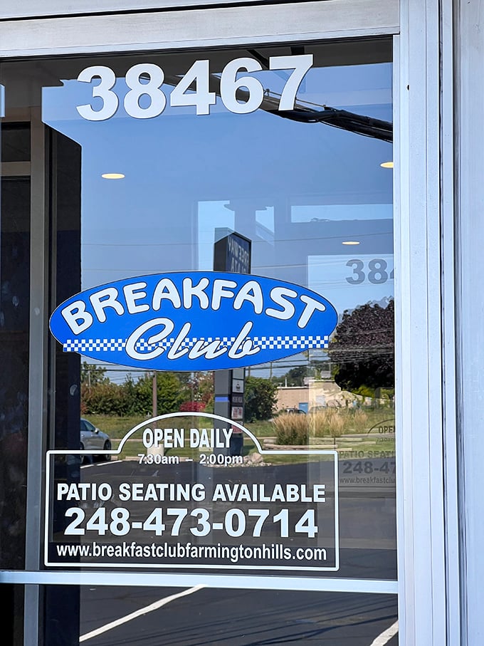 The door tells you everything you need to know: open daily, patio seating available, and a phone number to hear those magical words—"your table is ready."