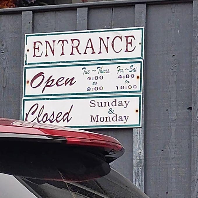 The hours sign reveals the rhythm of rural dining—closed Sundays and Mondays, because even legendary chicken fryers need a weekend.