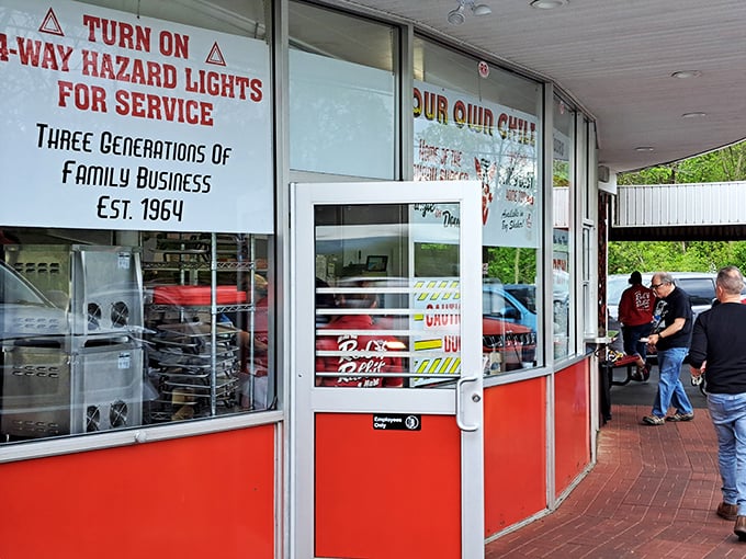 "Turn on 4-way hazard lights for service" reads the window—a charming reminder that some traditions are worth preserving in our tap-to-order world. 