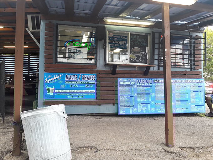 The order window—where dreams are placed and fulfilled. Blue menus announce the treasures waiting inside this wooden treasure chest.