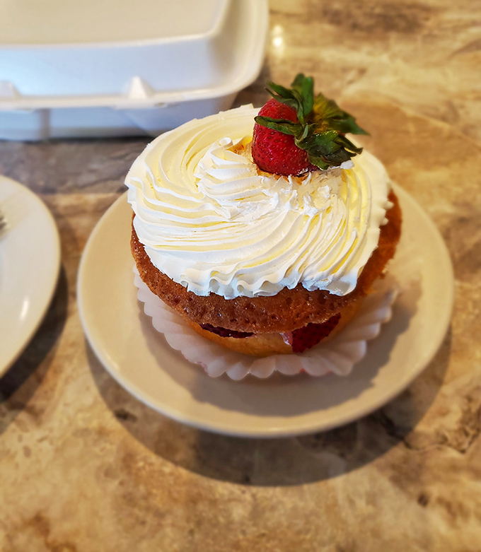 A strawberry shortcake that doesn't whisper sweet nothings – it shouts them from a cloud of whipped cream perfection.