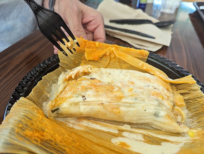 Unwrapping this tamale is like opening a present, except the gift is steamed masa perfection hiding savory treasures within.