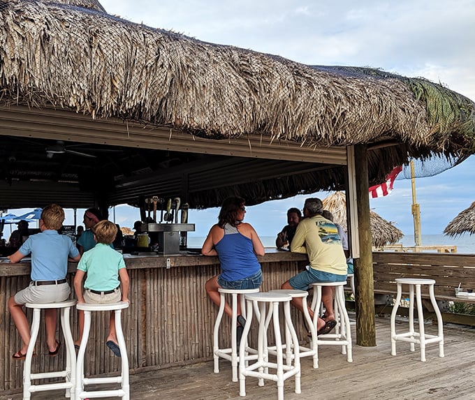 The tiki bar – where island drinks are poured with a heavy hand and conversations flow as easily as the Gulf breeze.