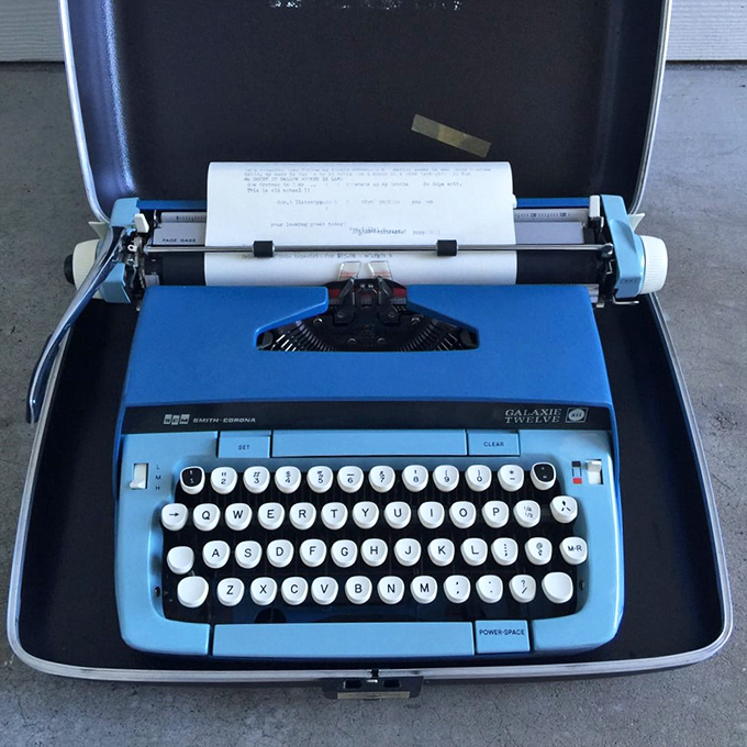 A baby blue Smith-Corona typewriter awaits your Great American Novel. Jack Kerouac would approve of this analog writing machine.