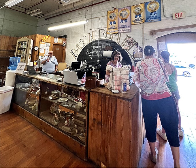 The checkout counter—where treasure hunters part with cash and gain conversation pieces. That smile says, "Yes, I really do need this 1940s butter churn."