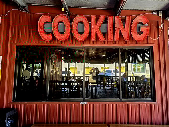 The "COOKING" sign isn't just information—it's a promise being fulfilled behind that window every single day.